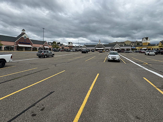 Colonial-style architecture and spacious parking welcome bargain hunters to Kensington Valley Outlets in Howell, where retail therapy meets Michigan's unpredictable skies.
