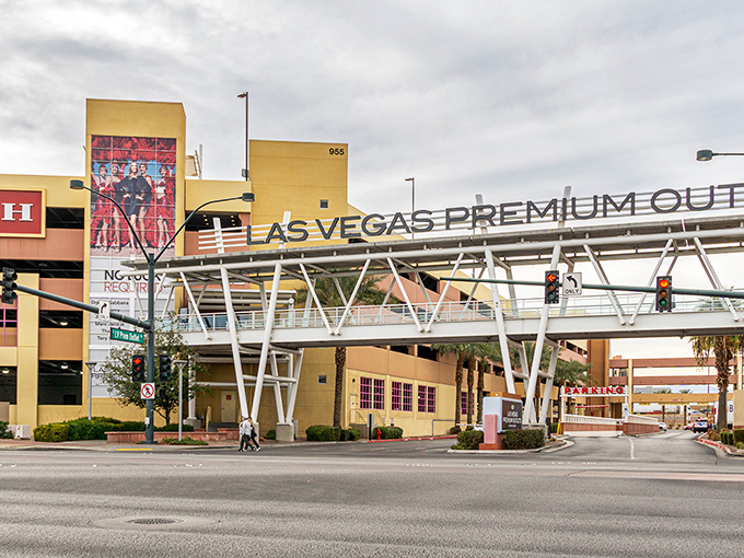 The iconic entrance to Las Vegas North Premium Outlets stands like a retail Colosseum, promising treasures within that won't empty your wallet like the nearby casinos.