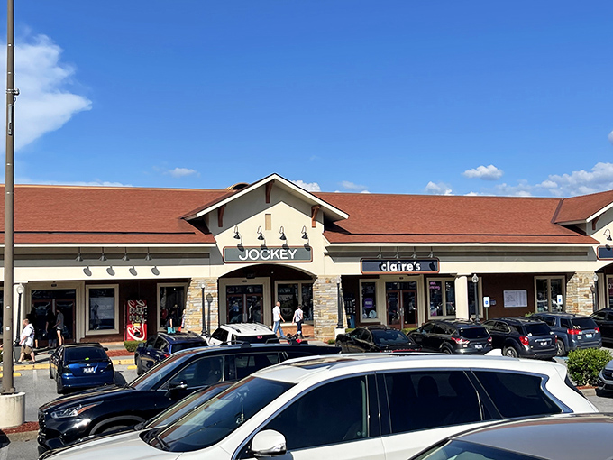 The grand entrance to shopping paradise. Tanger's architectural style blends mountain charm with retail efficiency &ndash; like a mullet haircut for buildings.