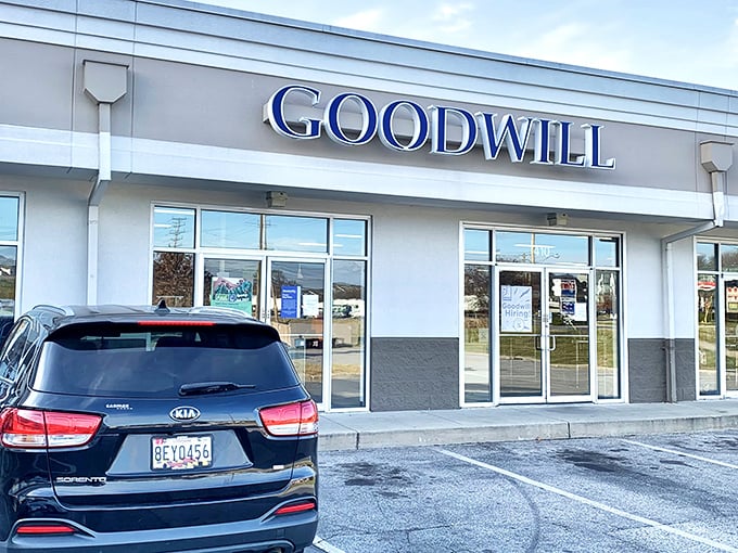 The blue Goodwill sign beckons like a lighthouse for bargain hunters. This unassuming storefront houses treasures waiting to be discovered.