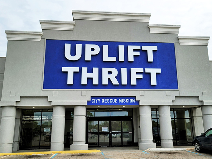The bold blue sign of Uplift Thrift stands out like a beacon for bargain hunters, promising treasures waiting to be discovered inside.