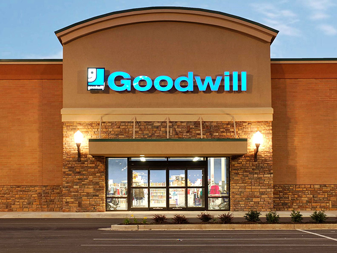 The blue Goodwill sign beckons like a lighthouse to bargain hunters. This Nicholasville storefront holds treasures waiting to be discovered inside its unassuming brick exterior.