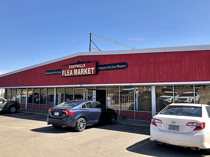 The iconic red exterior of Foothills Flea Market stands like a beacon of bargain possibilities, promising treasures within its unassuming walls.