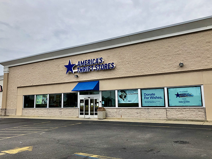 The blue star beckons bargain hunters like a retail lighthouse, promising treasures within America's Thrift Stores' unassuming exterior in Dothan.