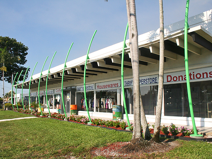 The distinctive green poles and clean storefront of Charity Thrift Stores stand out like a beacon for bargain hunters in Delray Beach.