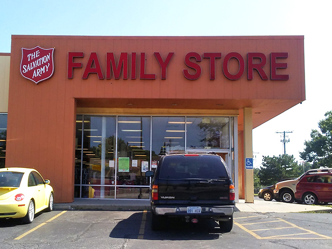 The iconic orange facade of the Salvation Army Family Store stands like a beacon of bargain-hunting possibility, promising treasures behind those glass doors.