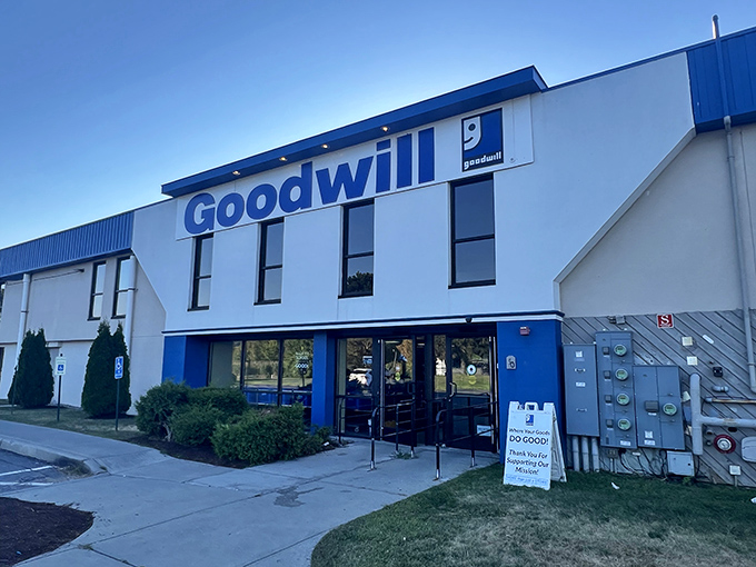 The blue-and-white facade of Goodwill Williston stands like a beacon of bargain possibilities under Vermont's clear skies.