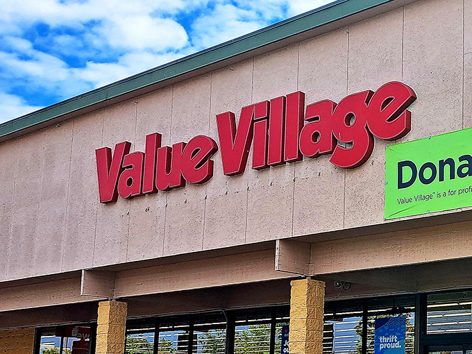 The iconic red Value Village sign against a blue sky promises treasure hunting adventures that would make Indiana Jones trade his whip for a shopping cart.