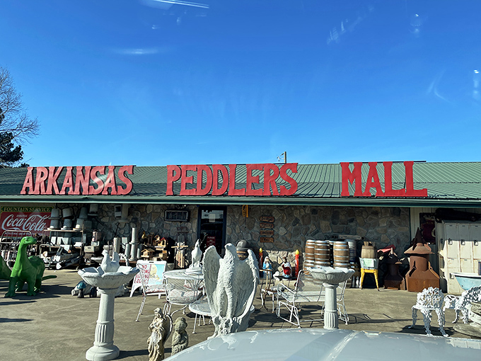 The stone facade and bold red signage of Arkansas Peddlers Antique Mall stands like a siren call to treasure hunters everywhere.