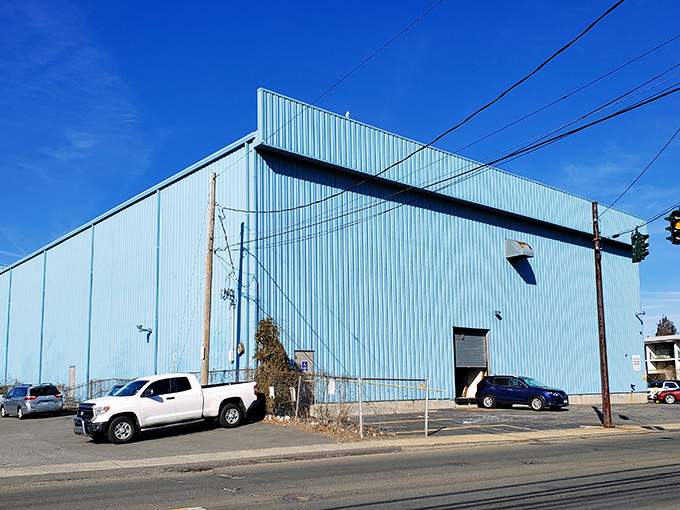The unassuming blue exterior hides a universe of treasures within, like finding a portal to the past behind those wooden doors. 