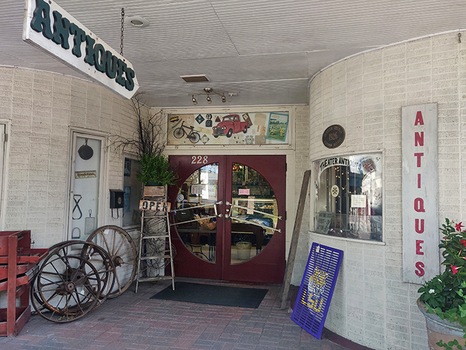 Red brick sidewalks lead to this antique shop entrance, where vintage treasures await behind those doors like actors in the wings, ready for their second act.