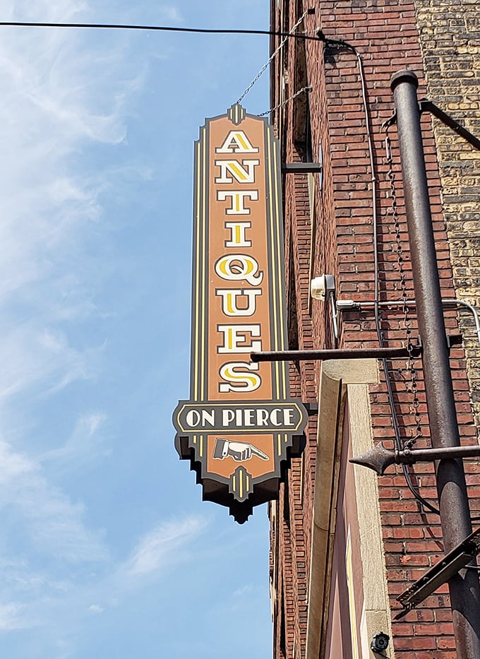 The vintage Art Deco sign for Antiques on Pierce stands as a beacon for treasure hunters, promising adventures in time travel without the flux capacitor.