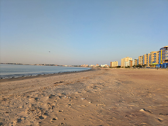 The crescent shoreline of Revere Beach stretches toward the horizon, where city meets sea in a perfect Massachusetts marriage of urban convenience and natural splendor.