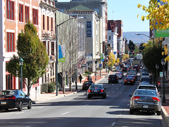 The streets of Hagerstown showcase a stunning blend of historic brick buildings standing side-by-side with trees dressed in their vibrant autumn colors.