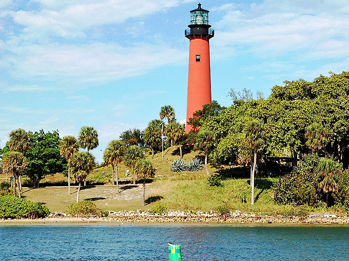 Like a crimson sentinel rising from an emerald island, Jupiter Inlet Lighthouse stands watch where the Loxahatchee River meets the Atlantic, painting the perfect Florida postcard.