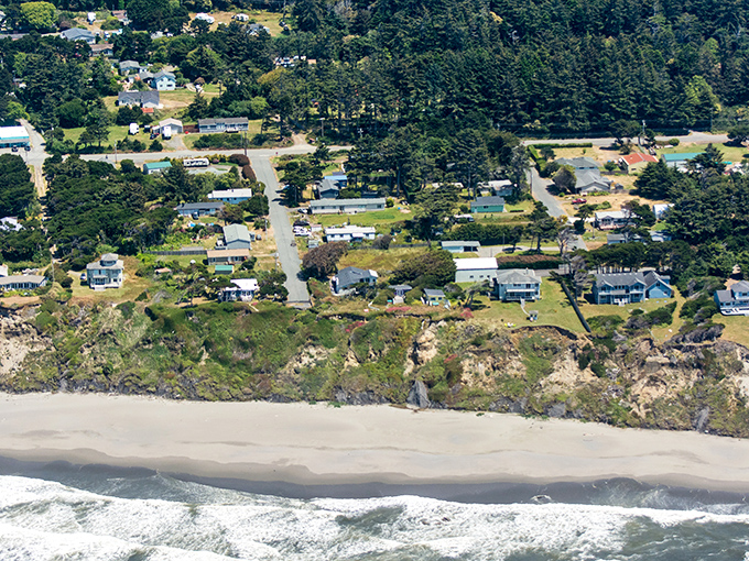 Aerial dreams come true: Nesika Beach unfolds like nature's perfect postcard&mdash;dramatic cliffs, pristine sand, and the endless Pacific stretching toward tomorrow.
