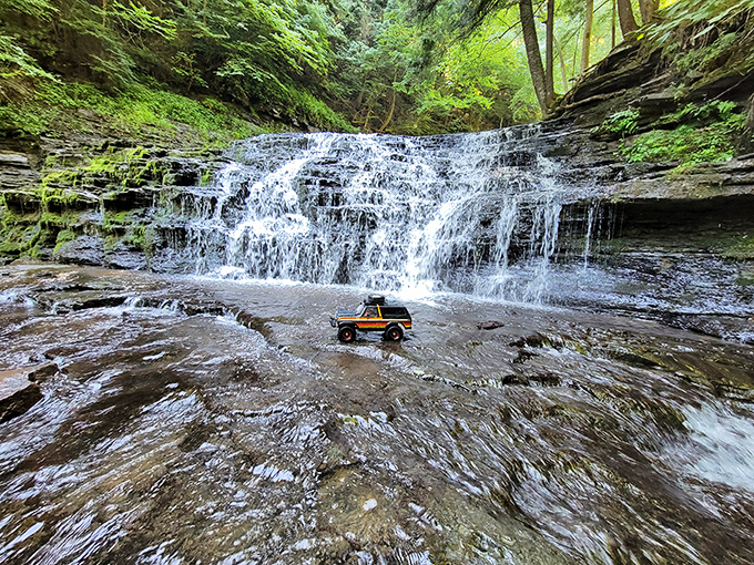 Nature's own waterfall playground where even toy trucks come for a splash. The cascading waters create a mesmerizing soundtrack to your woodland adventure.