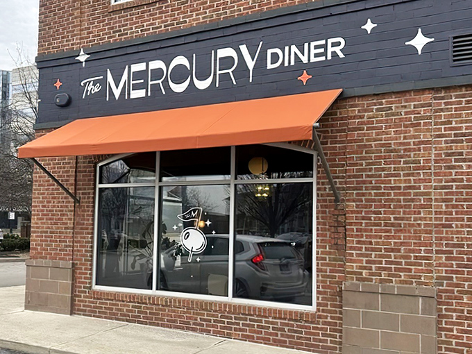 The cosmic journey begins at this unassuming brick corner in Columbus, where that orange awning signals delicious adventures await inside.