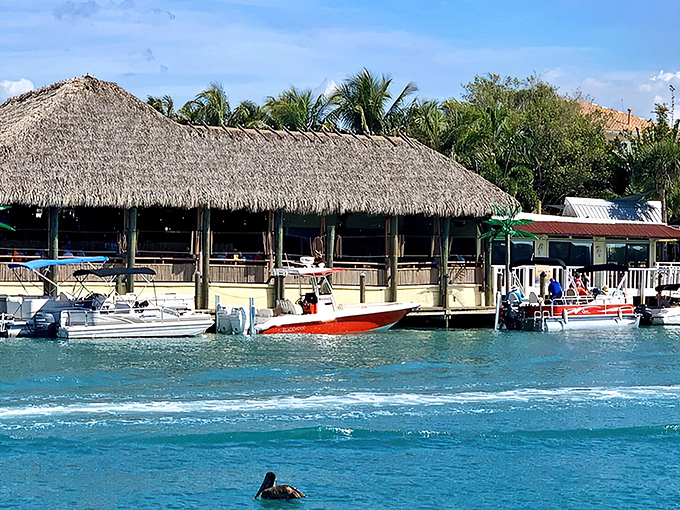 The iconic thatched roof of Pop's Sunset Grill beckons from across the water like a tropical mirage, only this one serves actual food.
