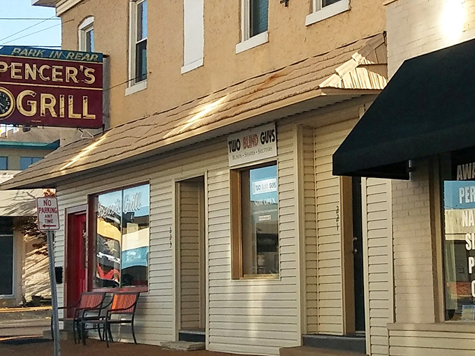 Morning sunshine bathes the exterior of Spencer's Grill, where the "Park in Rear" sign has guided hungry patrons for generations of Missouri mornings.
