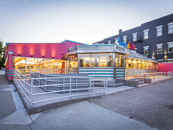 The classic Sugar n' Spice sign beckons hungry Cincinnatians like a neon promise of breakfast bliss. Those blue-striped steps lead to pancake paradise.
