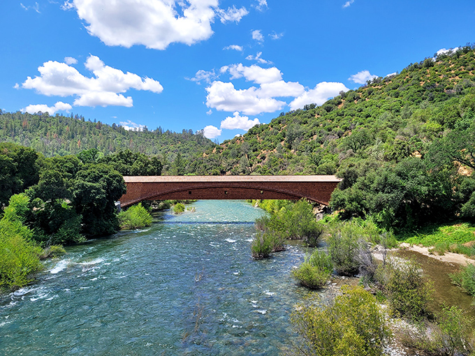 Looking down the bridge's interior is like peering into a wooden cathedral—intricate trusses and beams creating a mesmerizing geometric dance overhead.