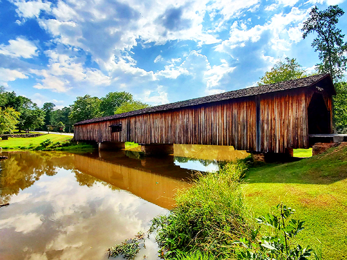 The honey-colored timbers of Watson Mill Bridge stretch across the South Fork River like a postcard from another century, inviting visitors to step back in time.