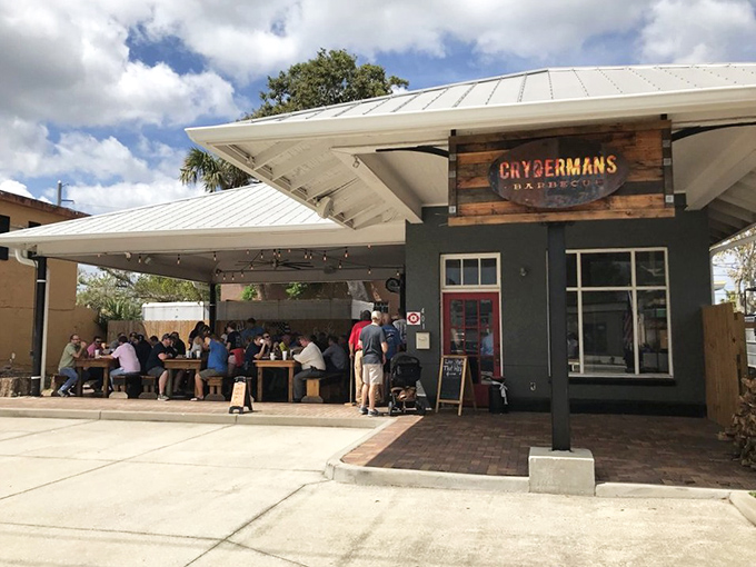 BBQ paradise found! Hungry patrons gather under string lights at Crydermans, where the smell of oak-smoked meats creates an irresistible gravitational pull.