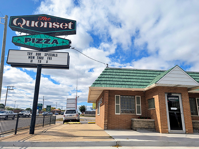 The iconic green-roofed Quonset hut stands like a time capsule on Grand Avenue, promising pizza perfection under Waukegan's big blue sky.
