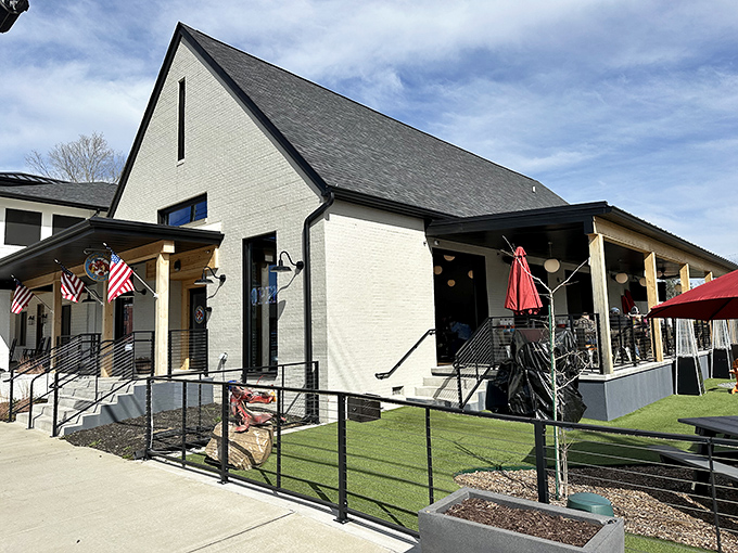 Pinchy's modern farmhouse exterior brings coastal charm to Tennessee, with its crisp white brick and welcoming patio that practically begs you to settle in for seafood.