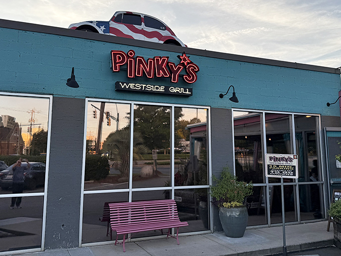 The sunset casts a golden glow on Pinky's iconic blue exterior. That pink bench isn't just for show &ndash; it's for catching your breath before the flavor explosion inside.