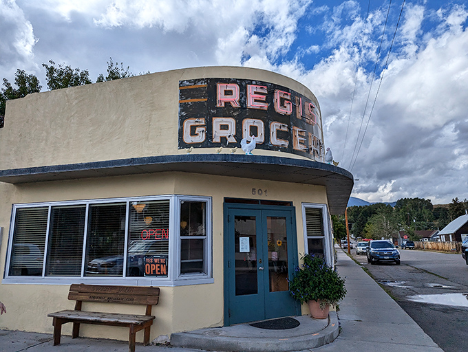 The iconic yellow facade of Café Regis stands as a beacon of breakfast hope in Red Lodge, where "grocery" history meets modern culinary magic.