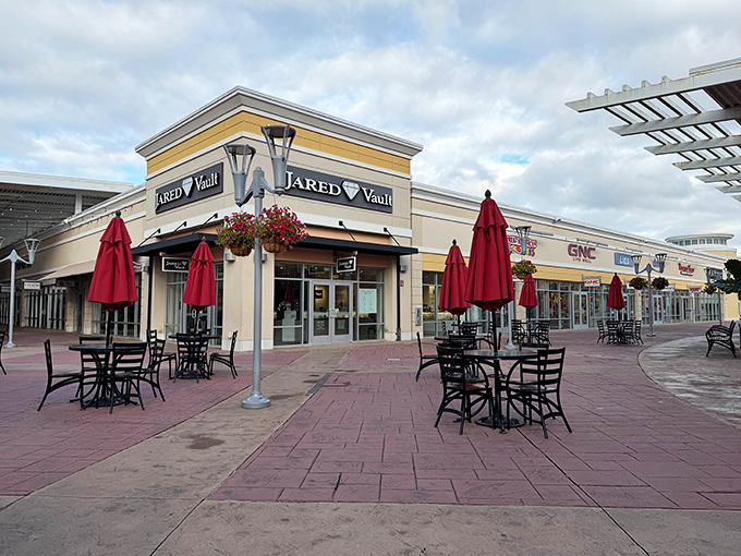 The outdoor dining area at Jared Vault beckons shoppers with those iconic red umbrellas &ndash; retail therapy's perfect intermission.
