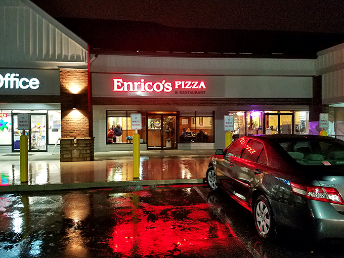 Even at night, Enrico's glowing sign serves as a beacon for pizza pilgrims, its red neon reflecting in puddles like a culinary lighthouse.