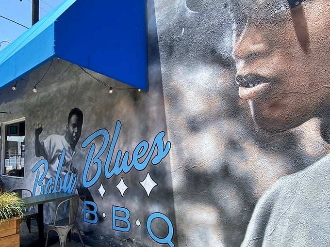 The striking mural outside Baby Blues BBQ sets the tone &ndash; this isn't just dinner, it's a cultural experience wrapped in smoke and soul.