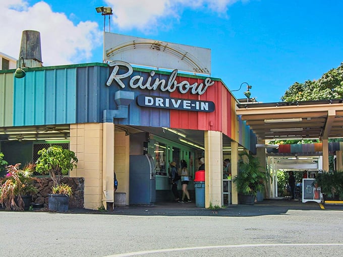 The iconic Rainbow Drive-In sign welcomes hungry souls to this Honolulu institution where comfort food dreams come true.
