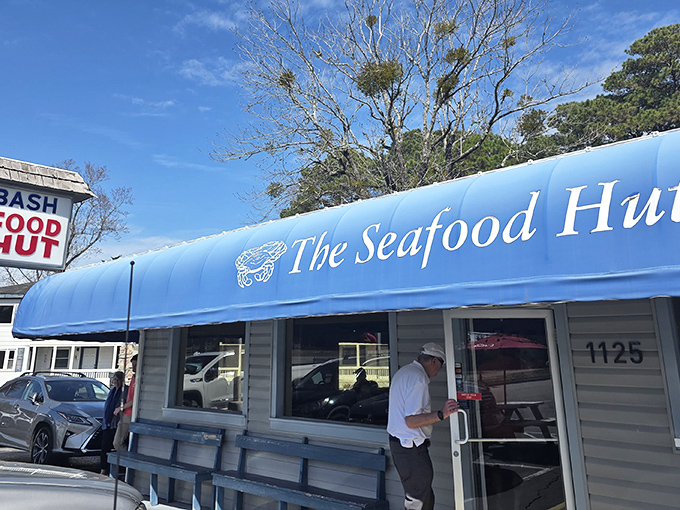 That iconic blue awning against the Carolina sky isn't just a restaurant sign&mdash;it's a beacon calling seafood lovers home to Calabash.