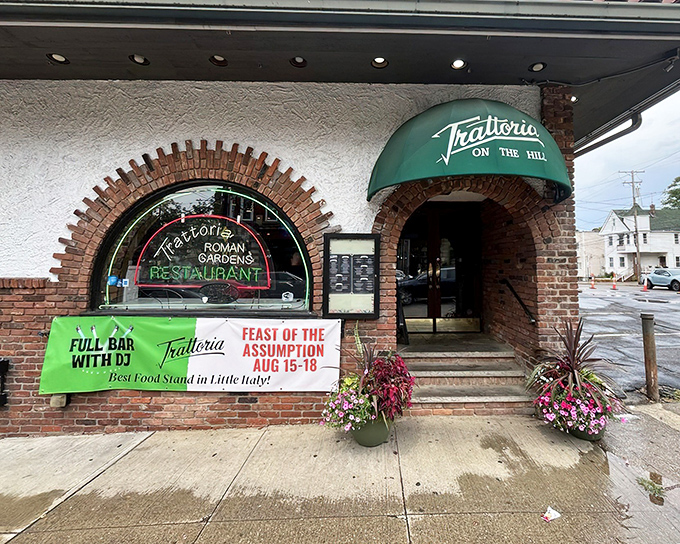 The classic brick-framed entrance with its emerald awning promises old-world Italian charm before you even step inside. Little Italy's culinary time machine awaits.