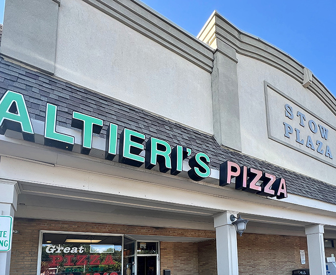 The classic neon sign beckons like an old friend &ndash; Altieri's Pizza, where strip mall exteriors hide culinary treasures within.