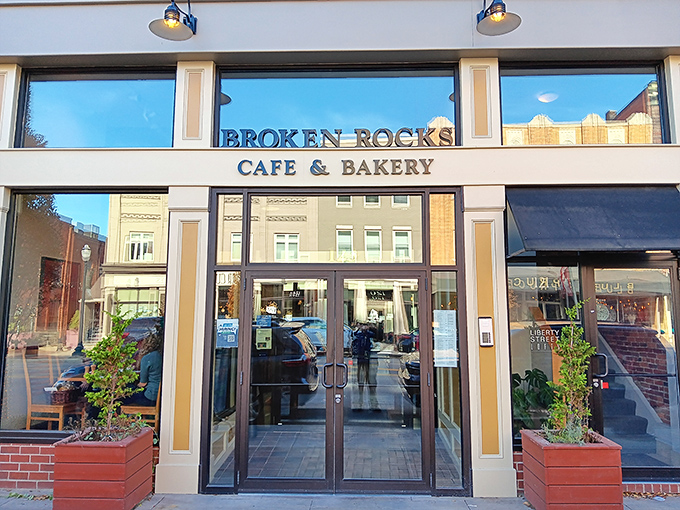 Daylight reveals the caf&eacute;'s elegant fa&ccedil;ade, where planters frame the entrance like culinary sentinels guarding the gateway to flavor town.