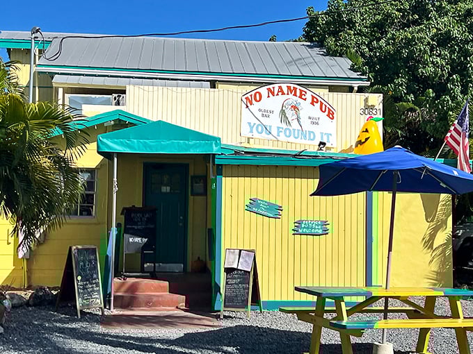 The cheerful yellow exterior of No Name Pub stands like a tropical beacon in Big Pine Key, promising culinary adventures within those unassuming walls.