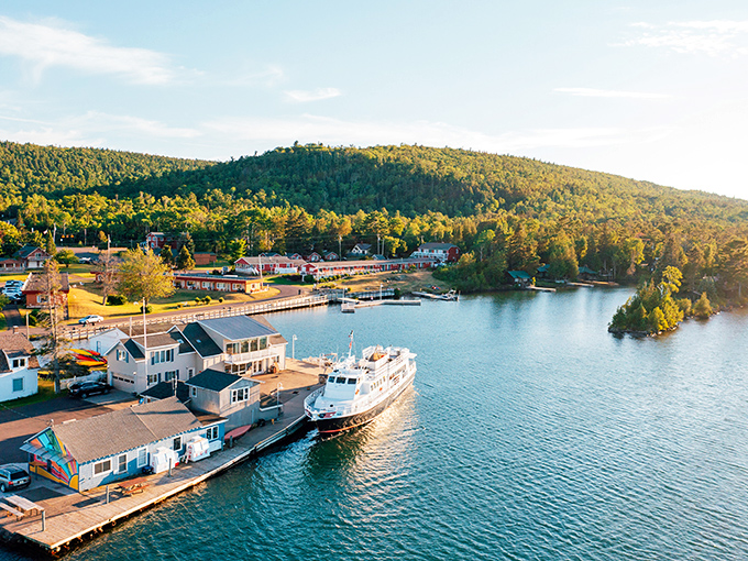 Aerial paradise where wilderness meets water. The Isle Royale Queen IV stands ready at the dock, promising adventures across Lake Superior's vast blue canvas.