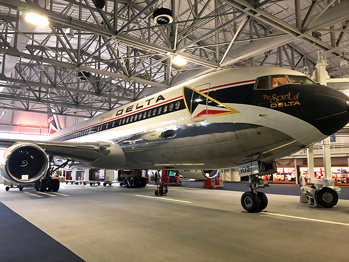 The Spirit of Delta Boeing 767 gleams under hangar lights, a metallic time capsule that makes modern planes look like boring flying buses.
