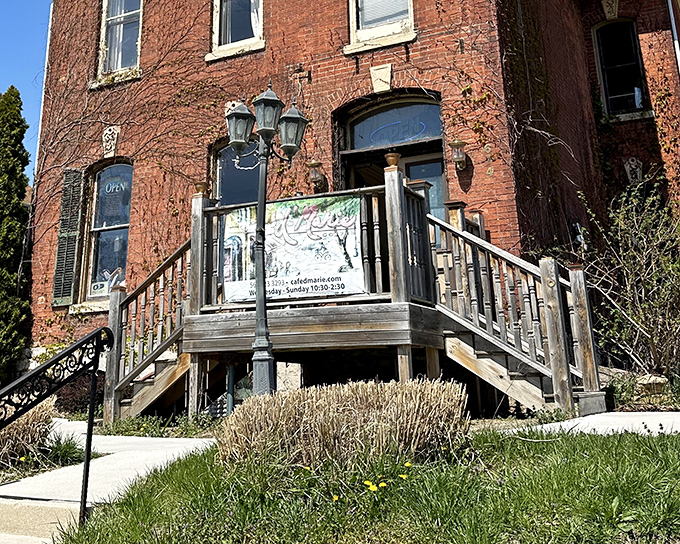 A historic brick building draped in autumn ivy, with wooden steps leading to culinary treasures. Like finding a European caf&eacute; mysteriously transported to Iowa.