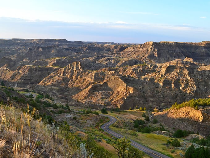 The winding road through Makoshika's badlands feels like driving into a painting where time forgot to keep moving forward.