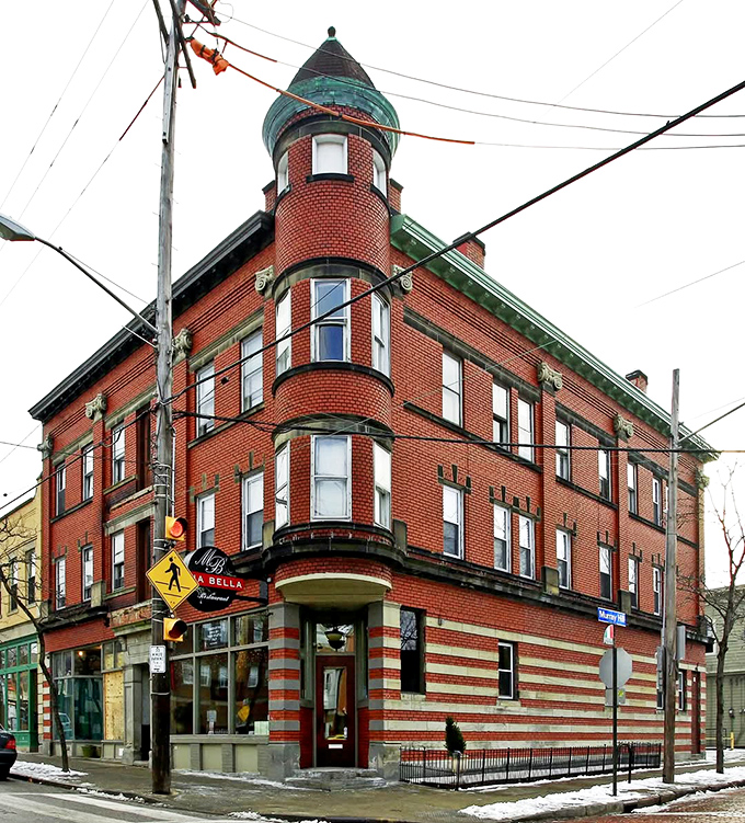 The corner turret of Mia Bella's historic brick building stands like a lighthouse for hungry souls navigating Cleveland's Little Italy. Architectural charm meets culinary promise.