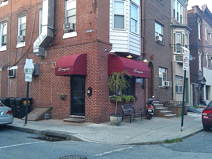 The unassuming corner brick building with burgundy awnings might fool you into thinking this is just another neighborhood spot. Spoiler alert: it's culinary magic in disguise.