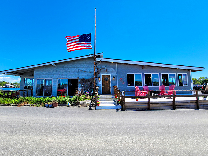 An American flag snaps in the coastal breeze above this unassuming seafood sanctuary, where lobster dreams come true and diet plans go to die.