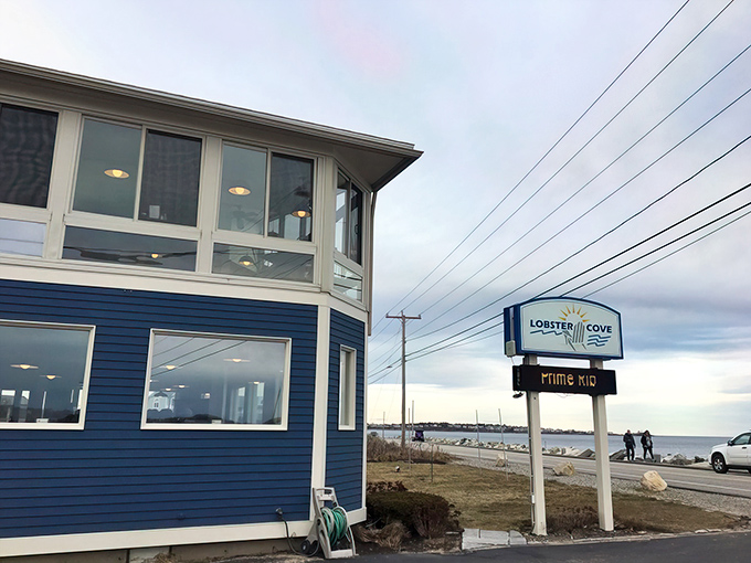 The blue clapboard exterior of Lobster Cove stands like a maritime sentinel, promising seafood treasures within its waterfront walls.