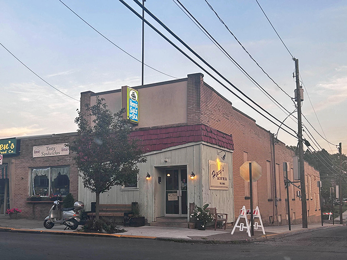 Twilight transforms this modest seafood sanctuary into a beacon for hungry travelers. The weathered blue siding tells stories of countless satisfied diners.